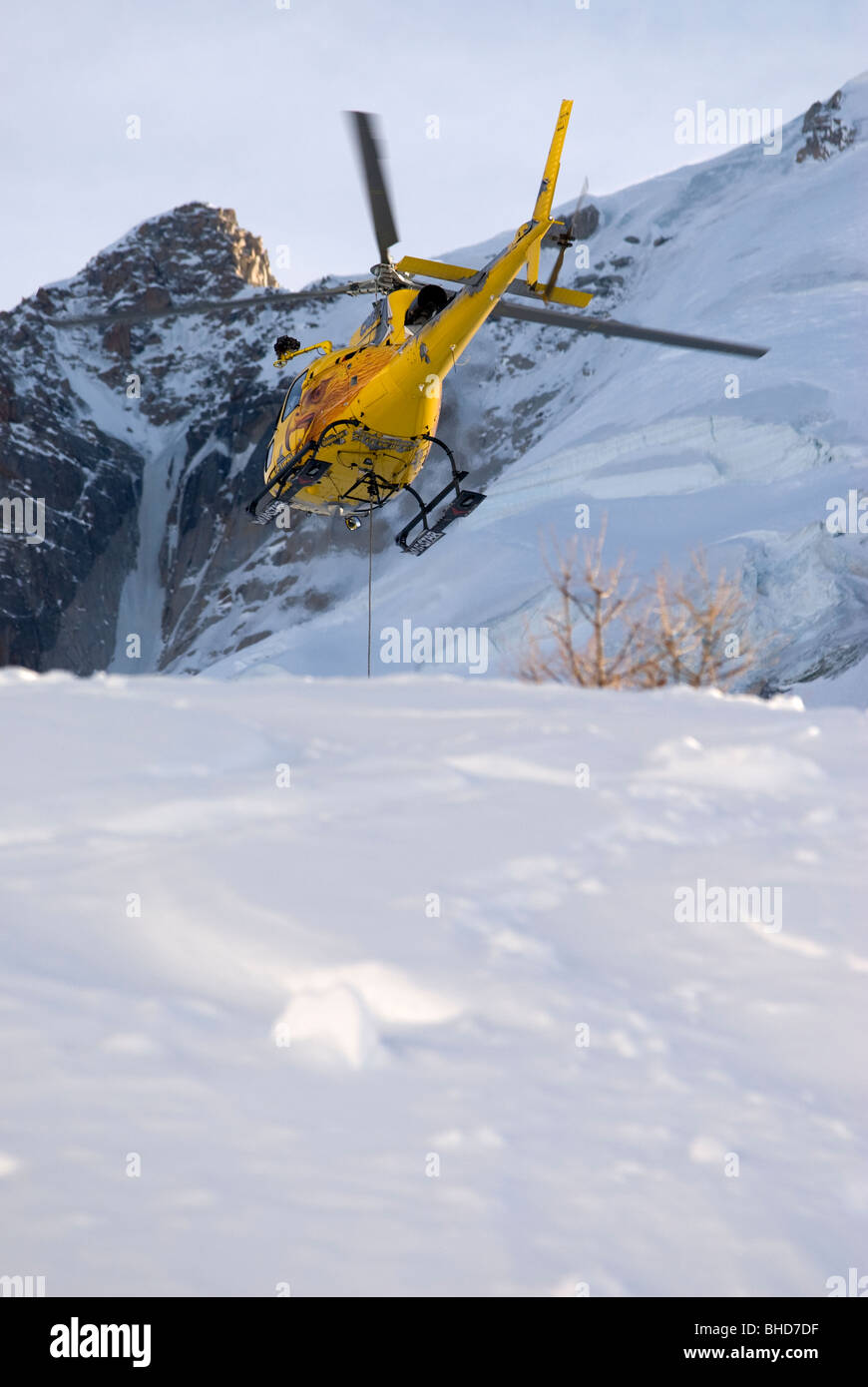 Helicopter flying low over snow fields close to the Argentiere glacier ...