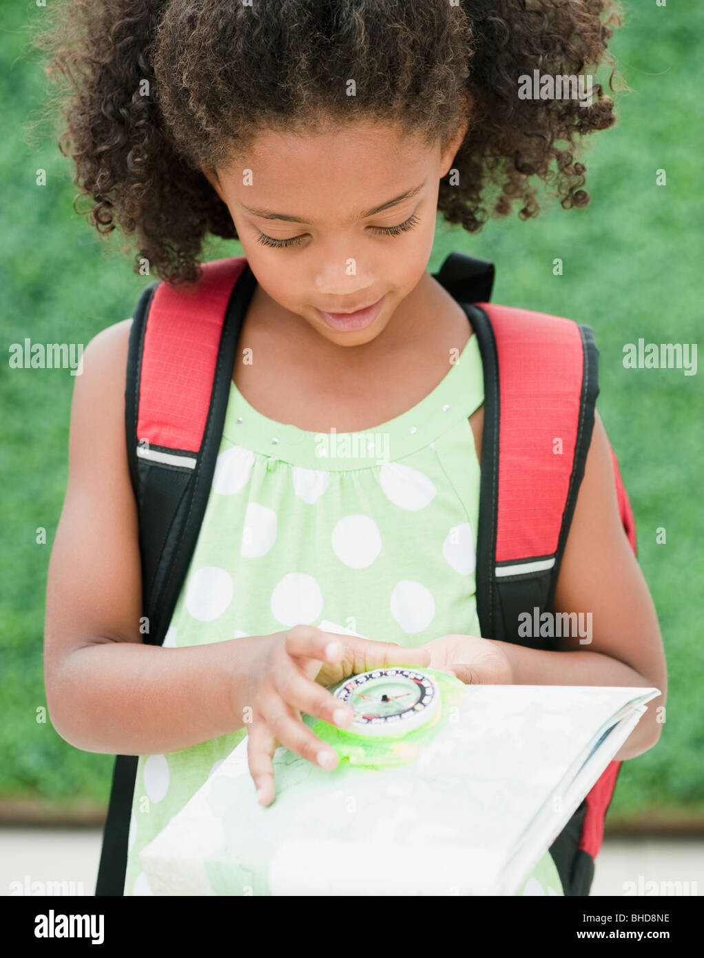 Mixed race girl looking at compass Stock Photo - Alamy