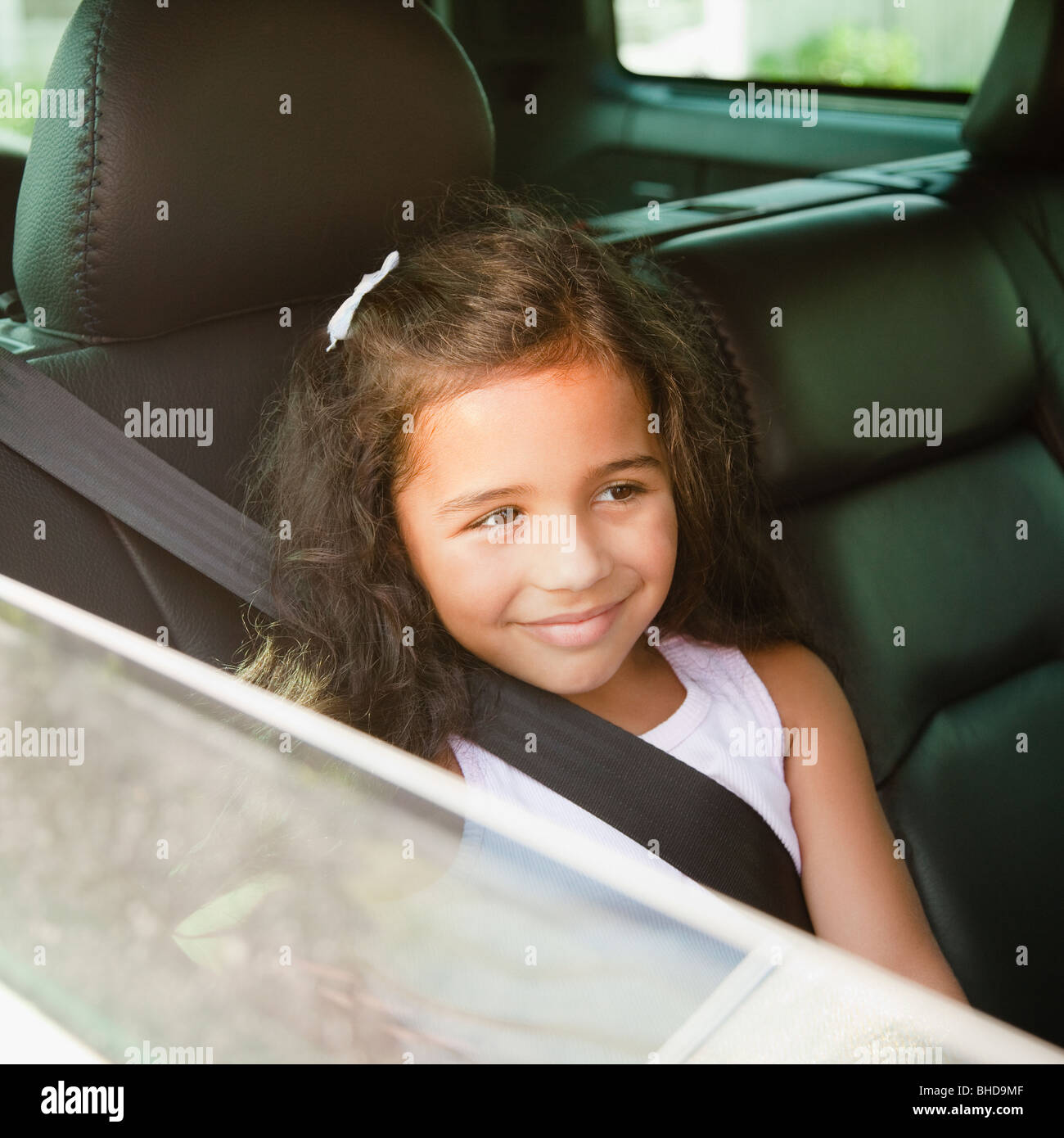 Hispanic girl in back seat of car Stock Photo - Alamy