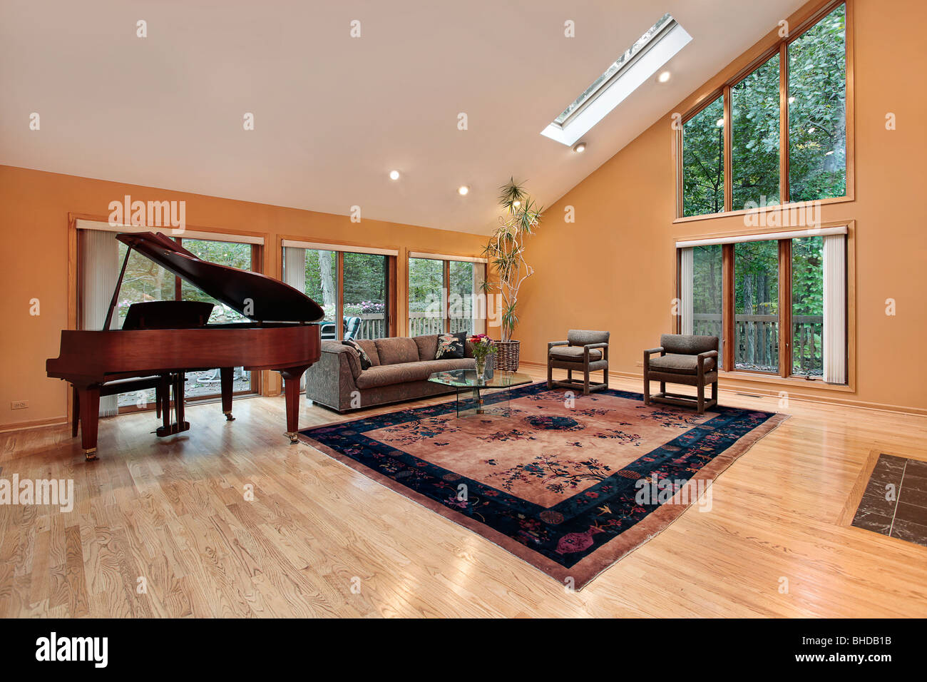 Living room in luxury home with two story window Stock Photo - Alamy