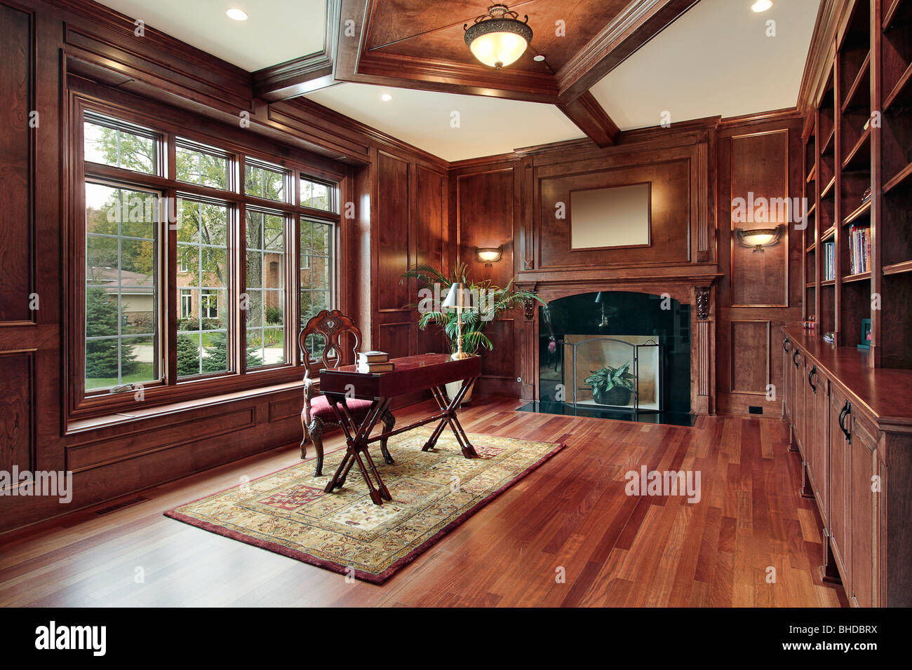 Elegant library in luxury home with black marble fireplace Stock Photo ...