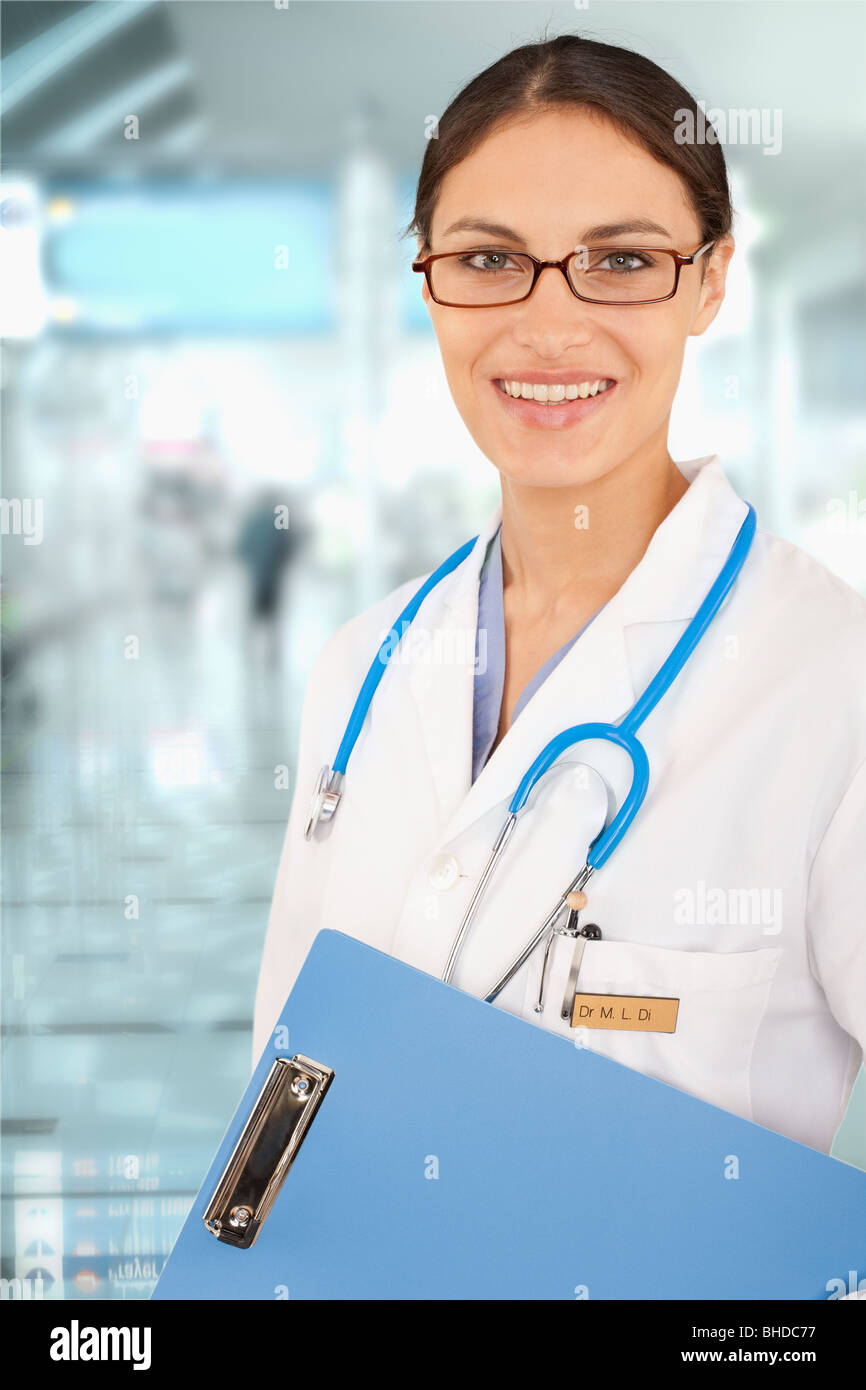Mixed race doctor holding medical chart in hospital Stock Photo - Alamy
