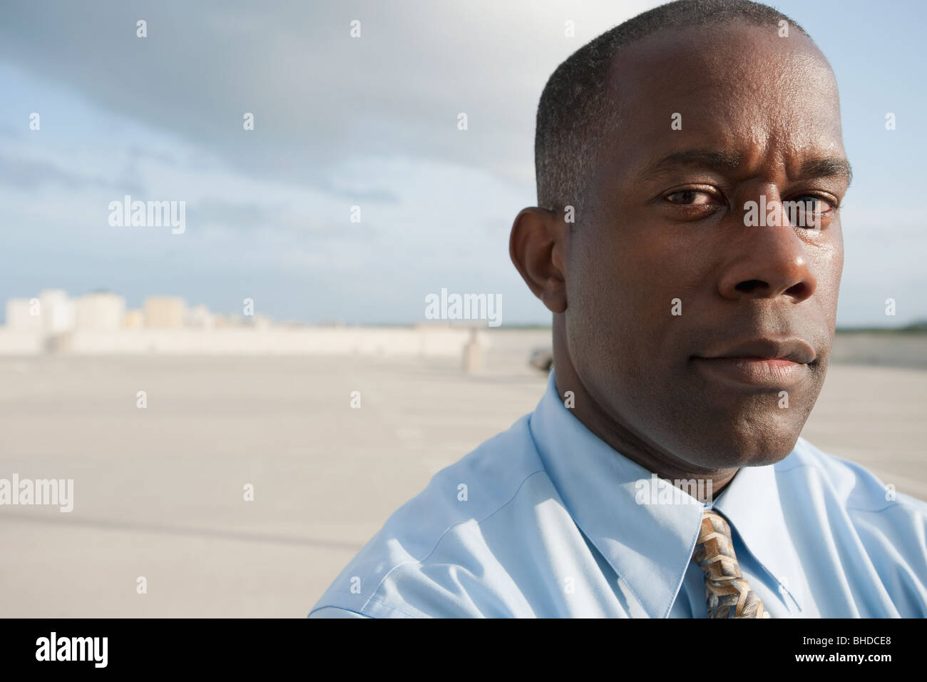 African businessman standing in parking lot Stock Photo - Alamy