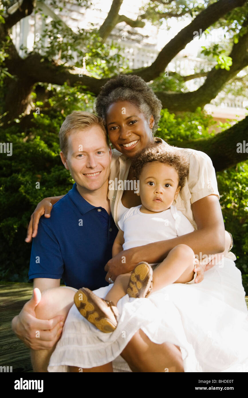 Multi-ethnic family smiling in garden Stock Photo - Alamy