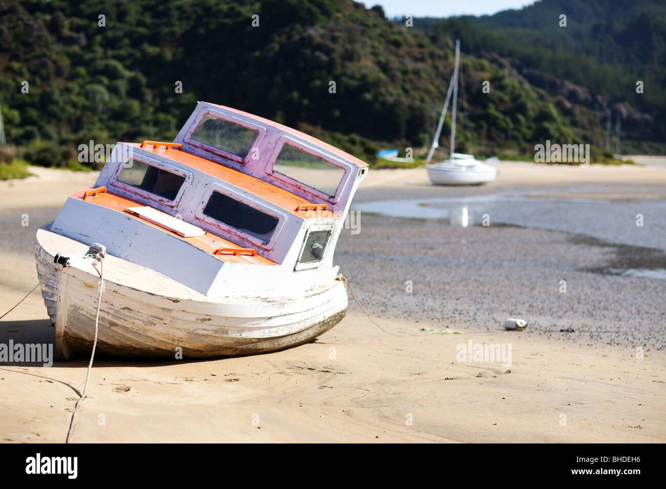 Beached boat with anchor on the Abel Tasman National Park Coastline ...