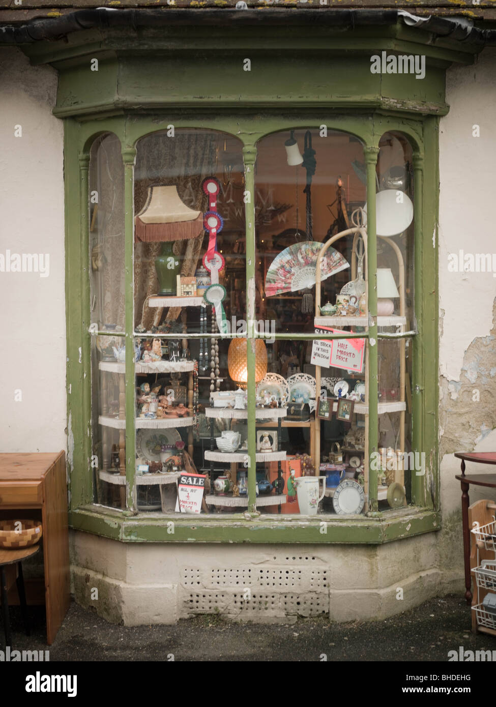 Antiques shop window selling bric a brac Stock Photo - Alamy