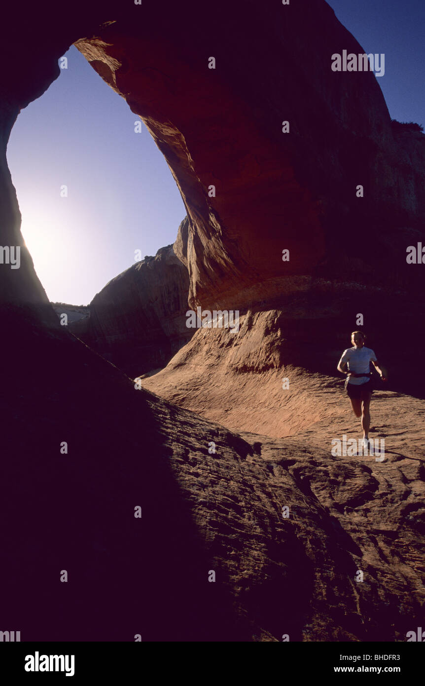 Woman running through arch Stock Photo - Alamy