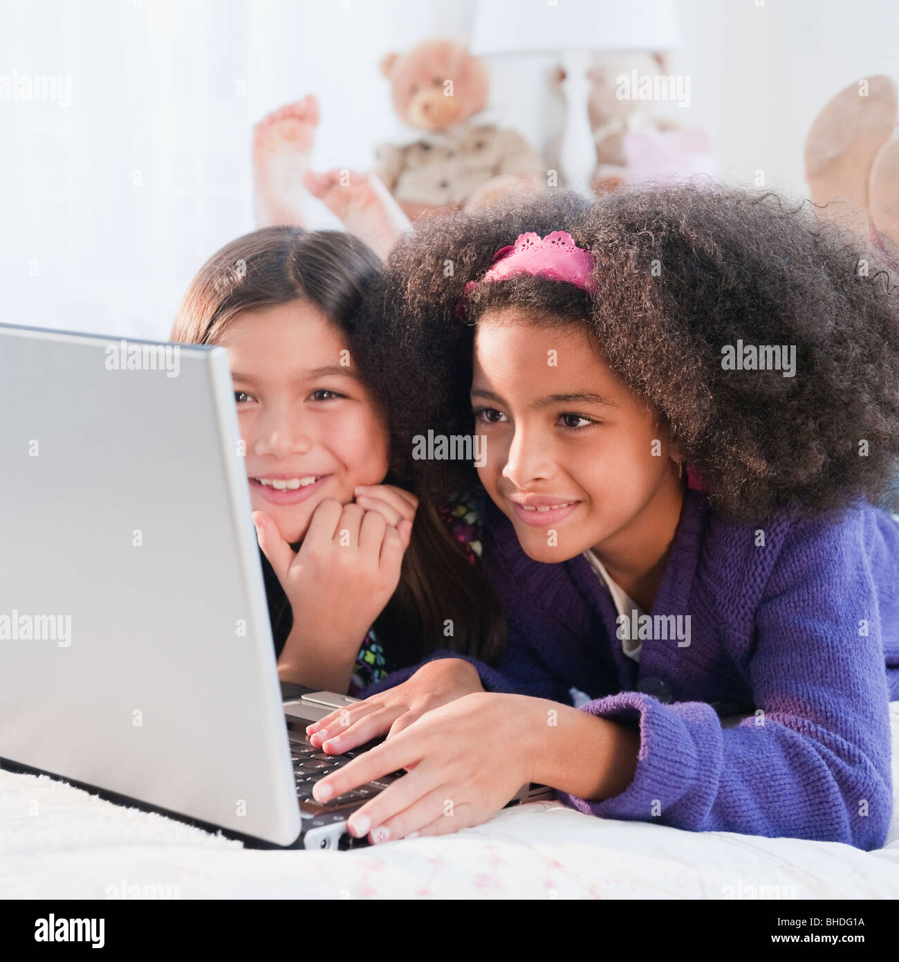 Girls using laptop together Stock Photo - Alamy