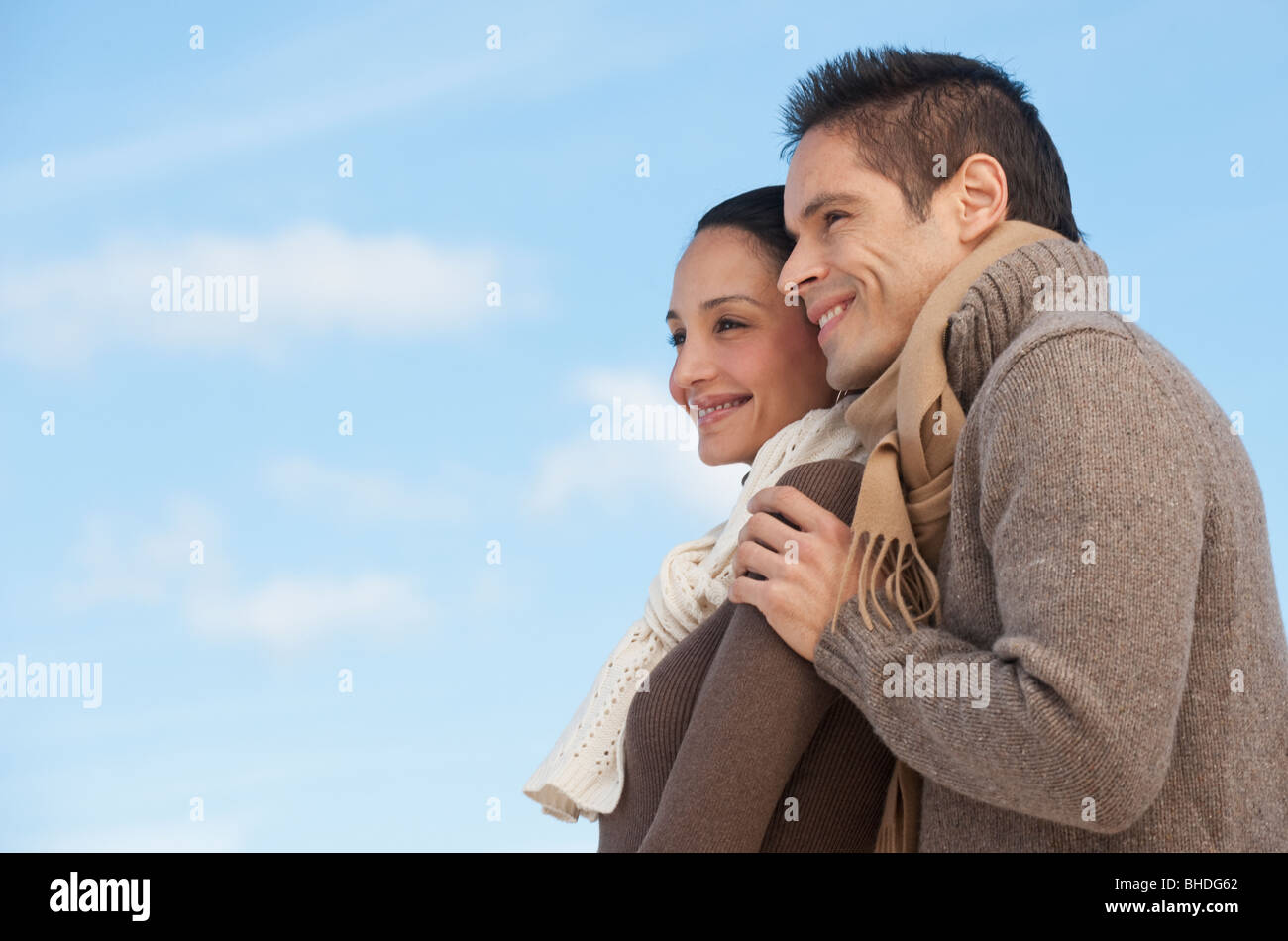 Hispanic couple hugging Stock Photo - Alamy