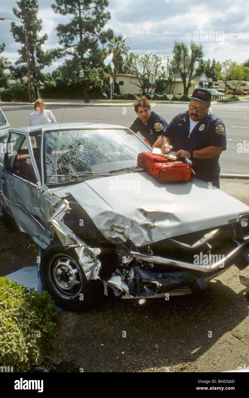 Police and paramedics assist victims in auto crash collision accident ...