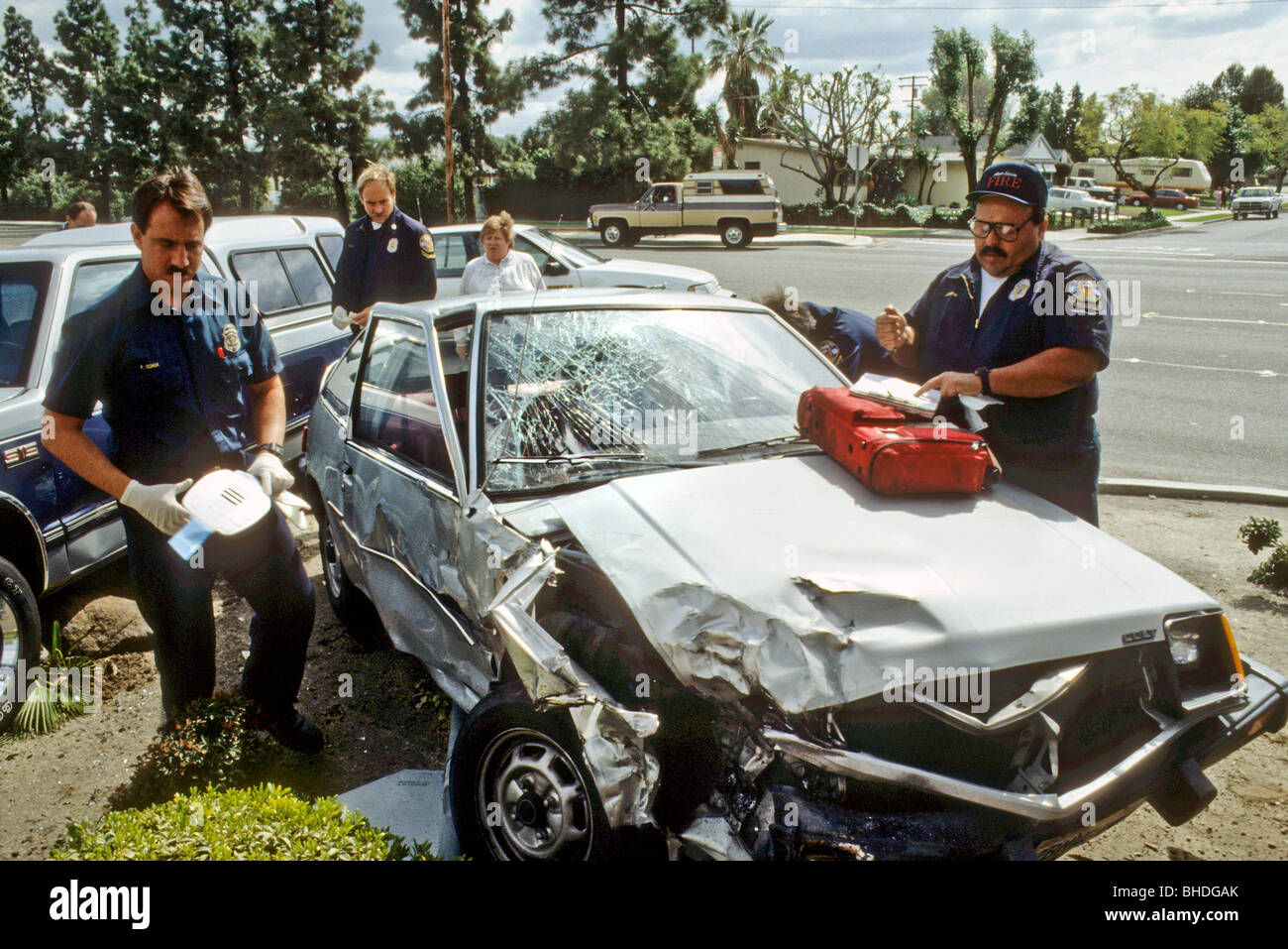 Police and paramedics assist victims in auto crash collision accident ...