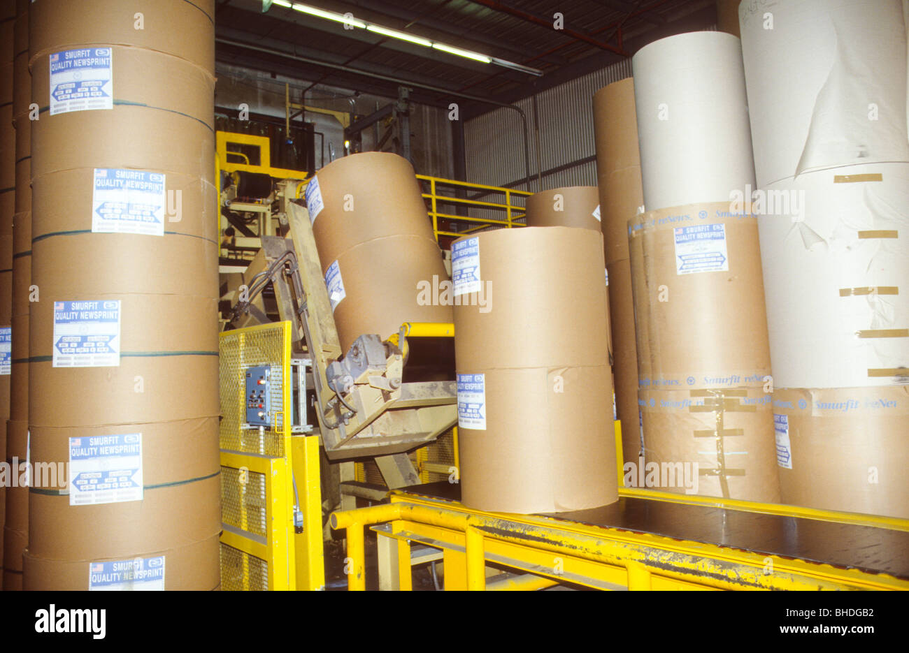 rolls of recycled paper exit paper making machine in factory green ...