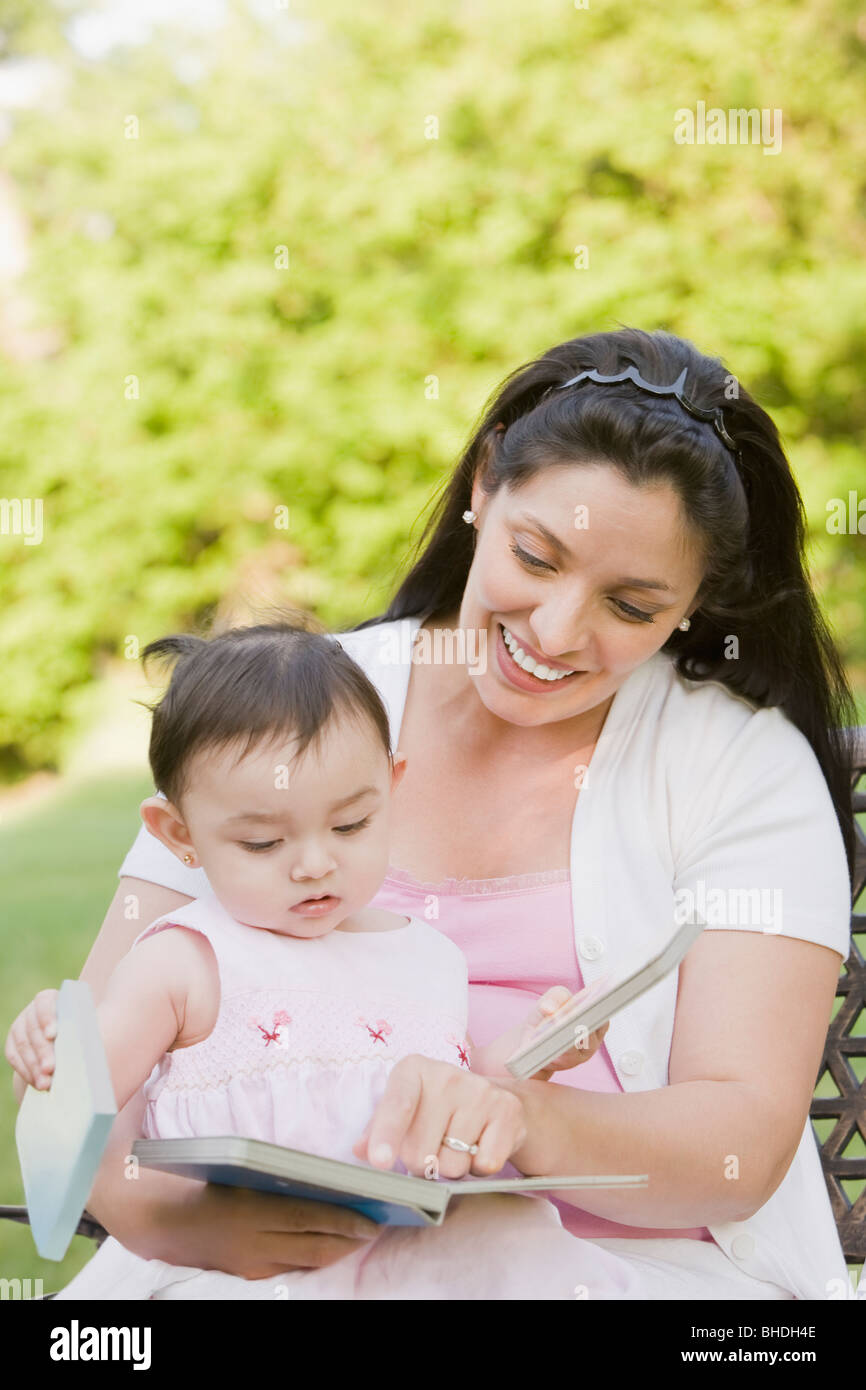 Hispanic mother reading book hi-res stock photography and images - Alamy