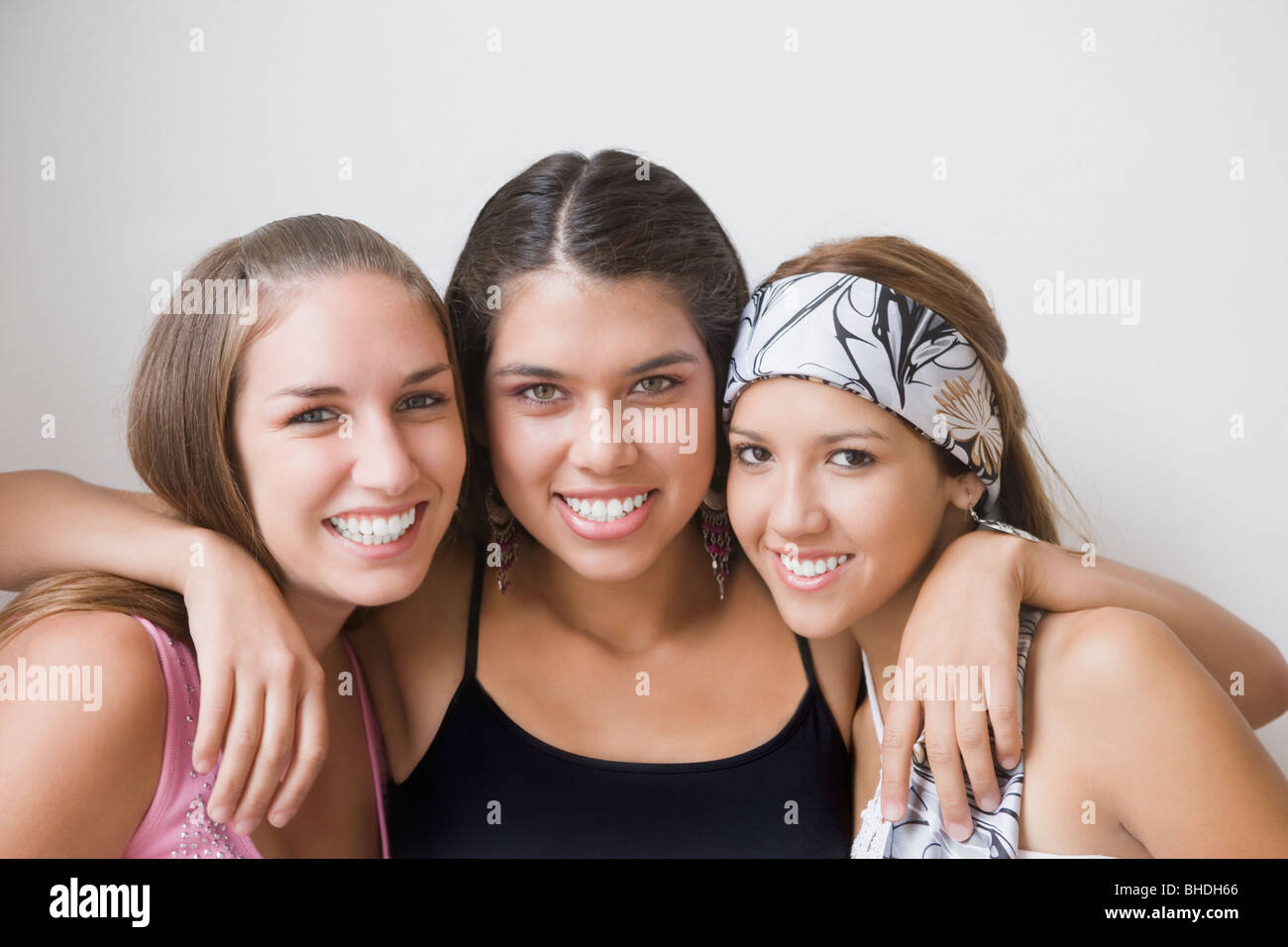 Hispanic friends hugging Stock Photo - Alamy