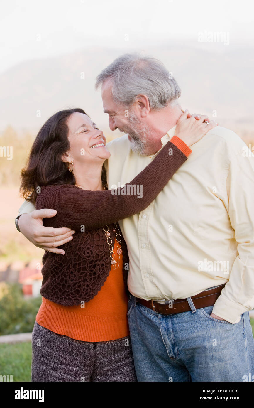 Hispanic couple hugging Stock Photo - Alamy