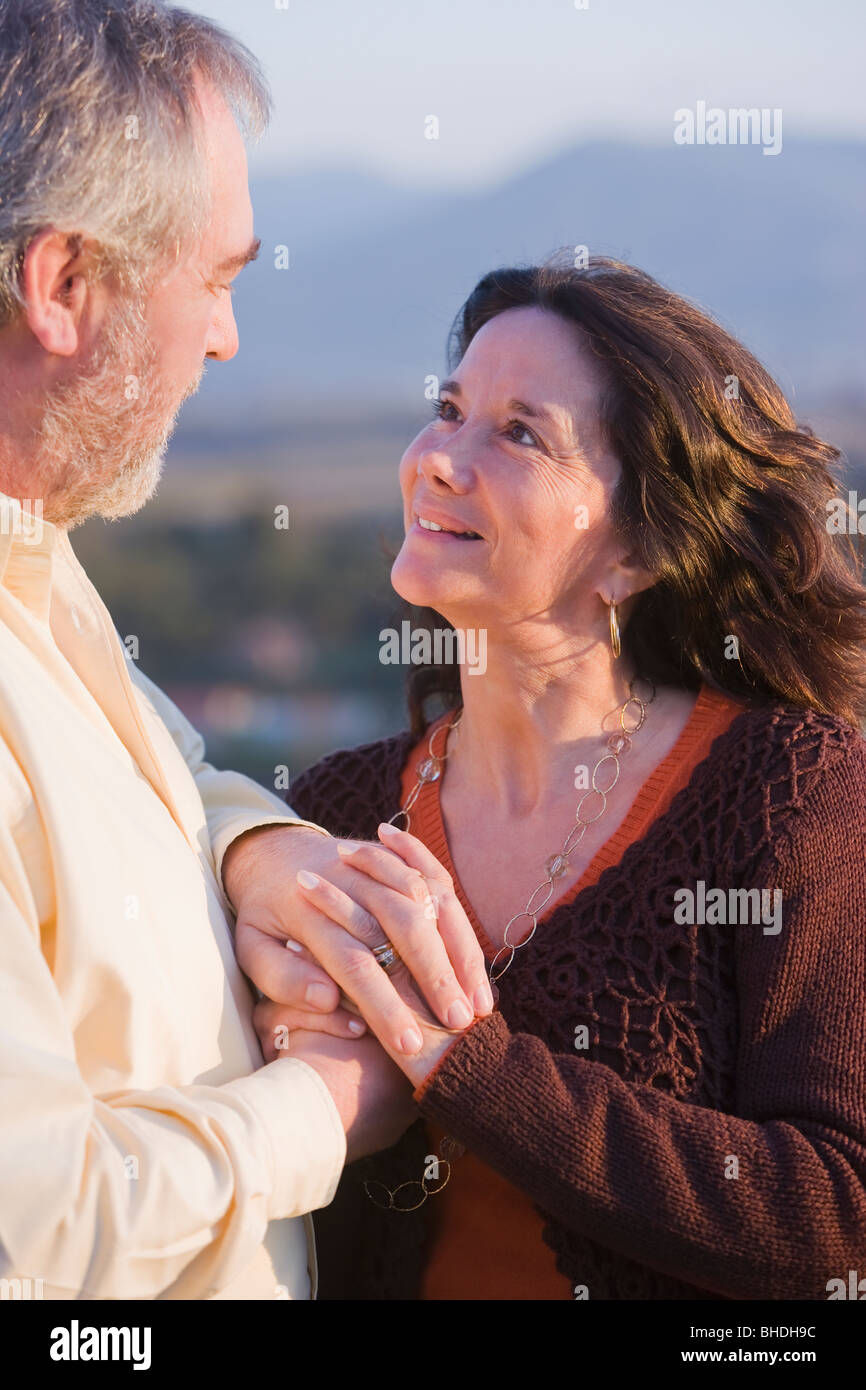 Hispanic couple holding hands Stock Photo - Alamy