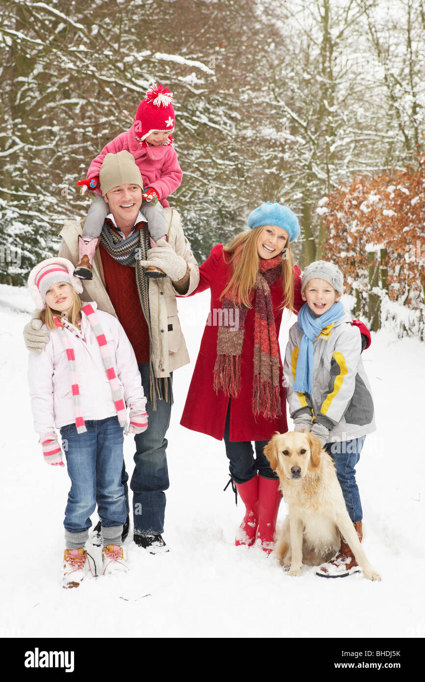Family Walking Through Snowy Woodland Stock Photo - Alamy