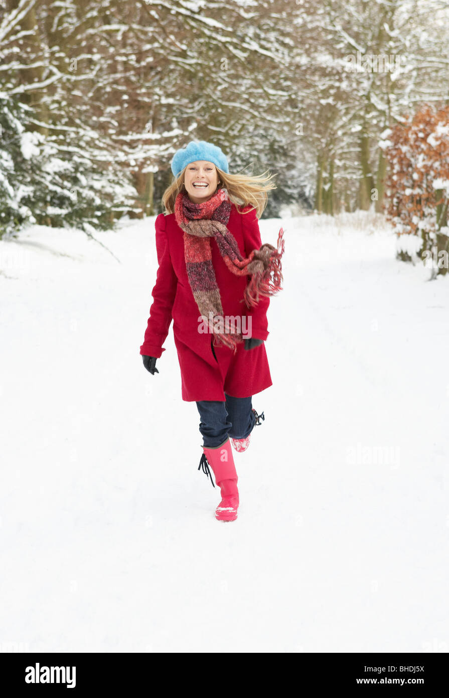 Woman Walking Through Snowy Woodland Stock Photo - Alamy