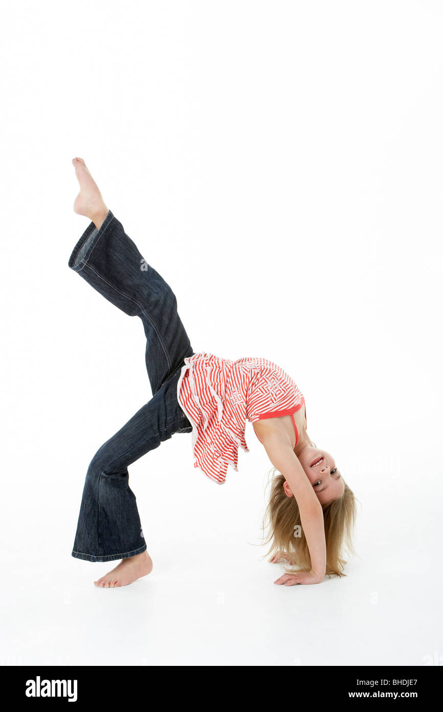 Young Girl Doing Backflip In Studio Stock Photo - Alamy