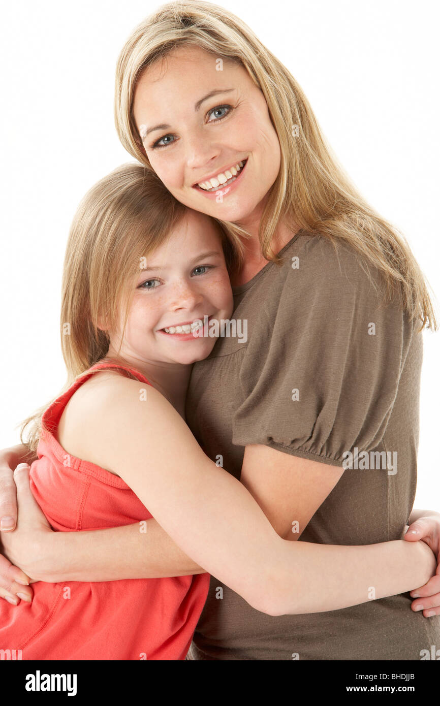 Studio Portrait Of Mother Hugging Young Daughter Stock Photo - Alamy