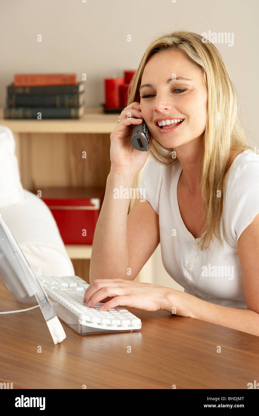 Mother At Home Using Computer Stock Photo - Alamy