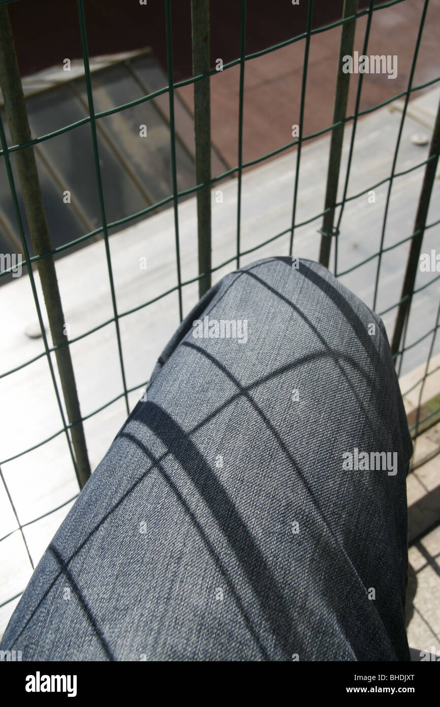 person sitting on terrace in inner city urban scene Stock Photo - Alamy