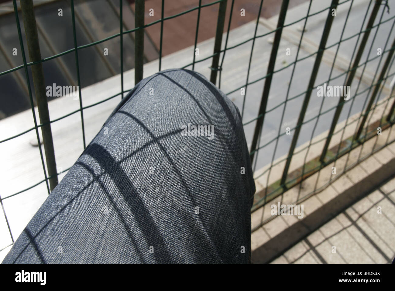 person sitting on terrace in inner city urban scene Stock Photo - Alamy