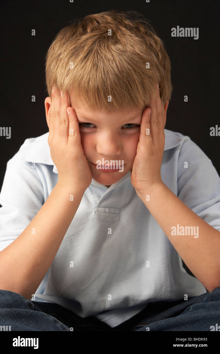 Studio Portrait Of Worried Boy Stock Photo - Alamy
