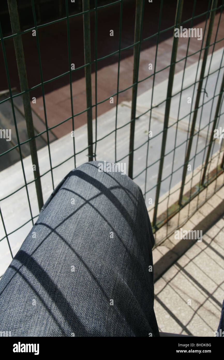 person sitting on terrace in inner city urban scene Stock Photo - Alamy