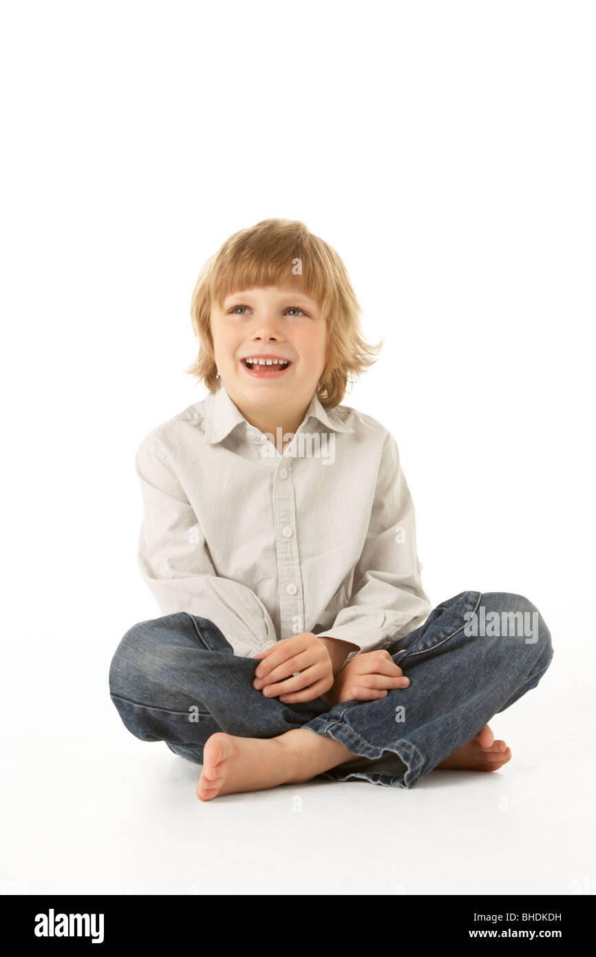 Young Boy Sitting In Studio Stock Photo - Alamy