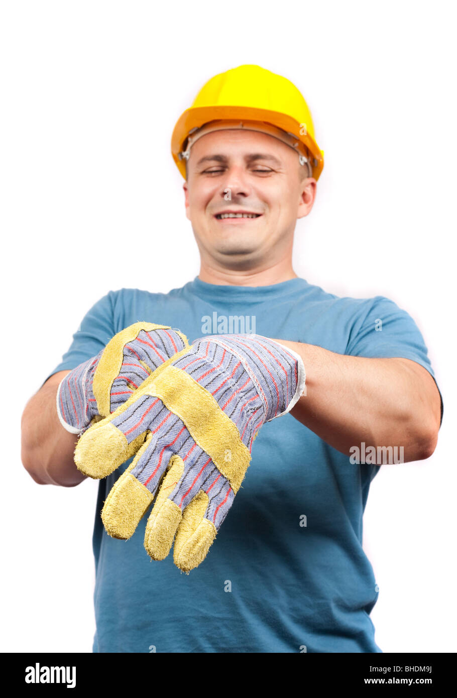Blue collar worker with yellow helmet putting on leather protection ...