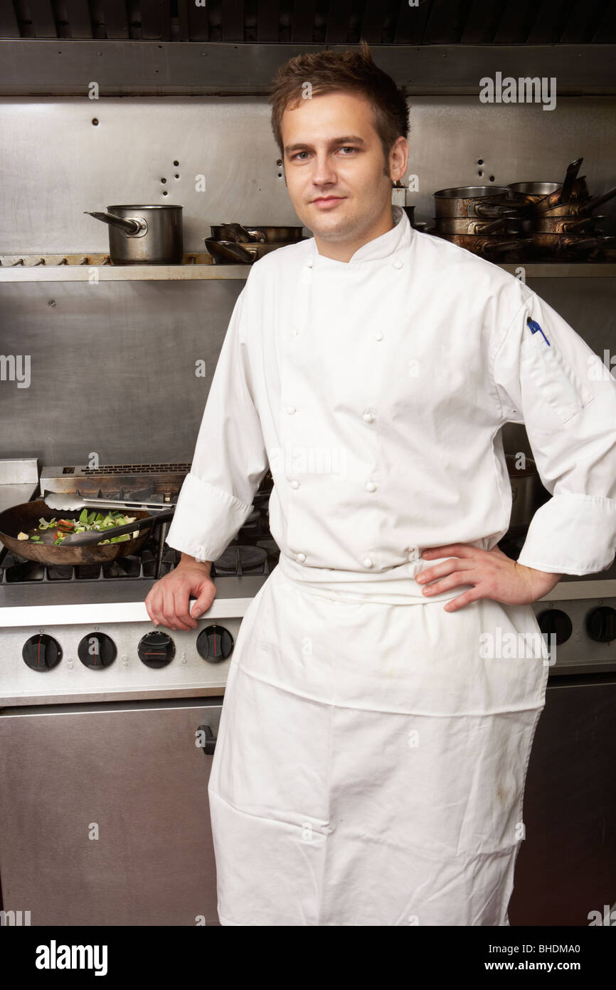 Male Chef Standing Next To Cooker In Restaurant Kitchen Stock Photo - Alamy