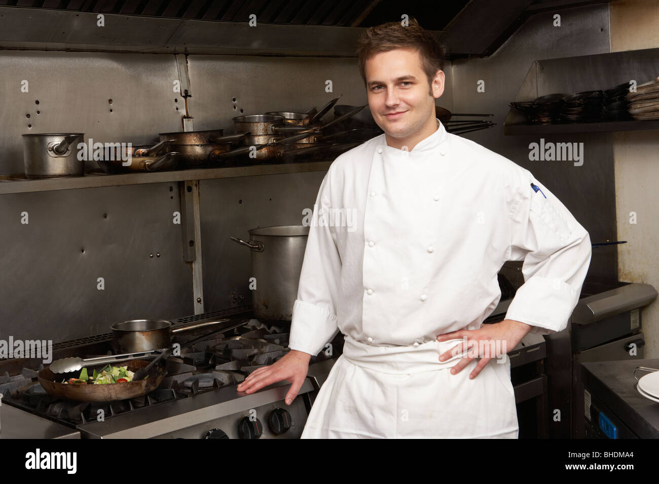 Male Chef Standing Next To Cooker In Restaurant Kitchen Stock Photo - Alamy