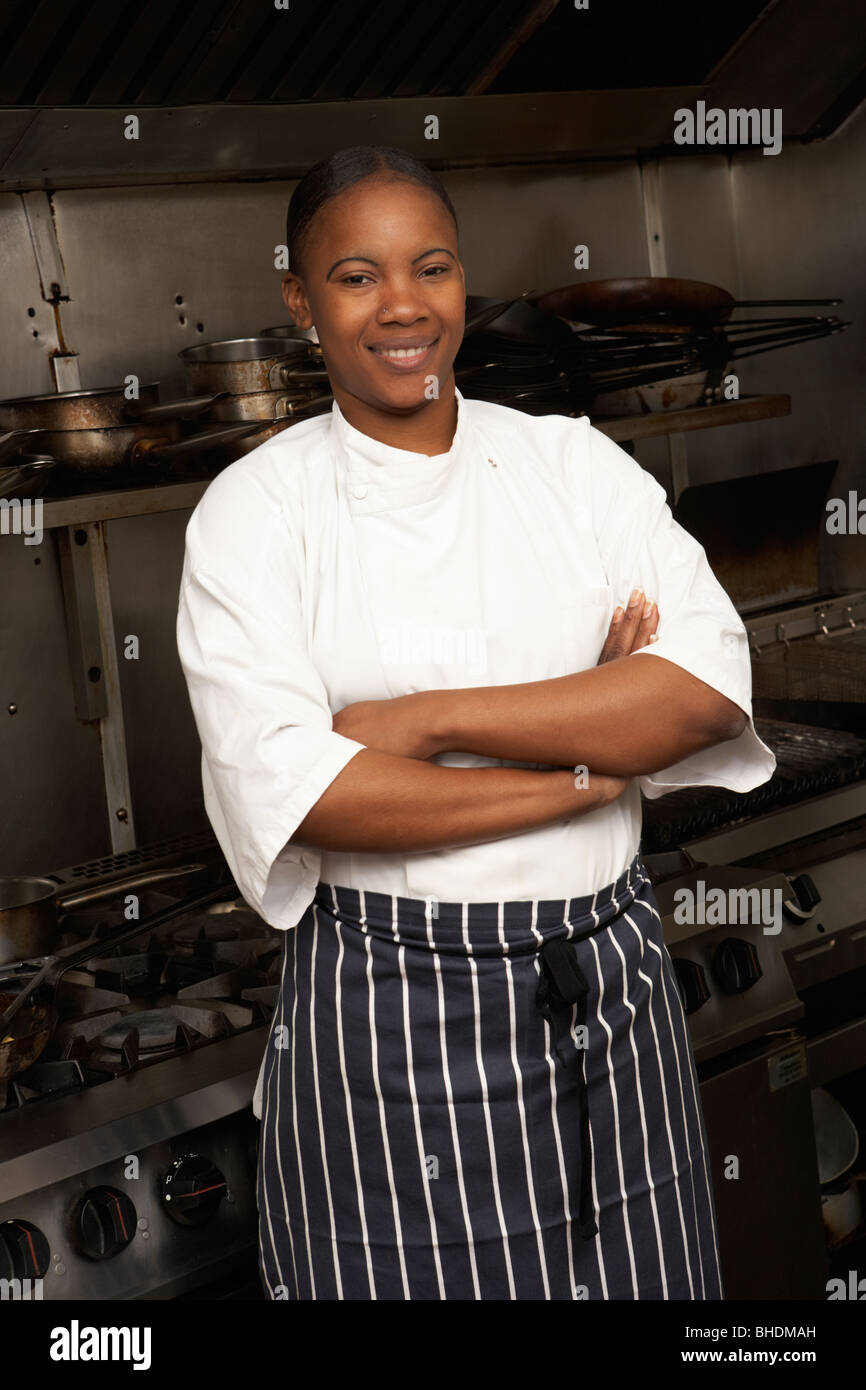 Female Chef Standing Next To Cooker In Restaurant Kitchen Stock Photo ...