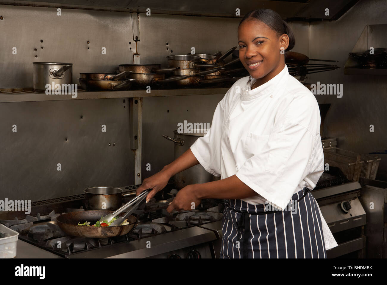Female Chef Preparing Meal On Cooker In Restaurant Kitchen Stock Photo ...