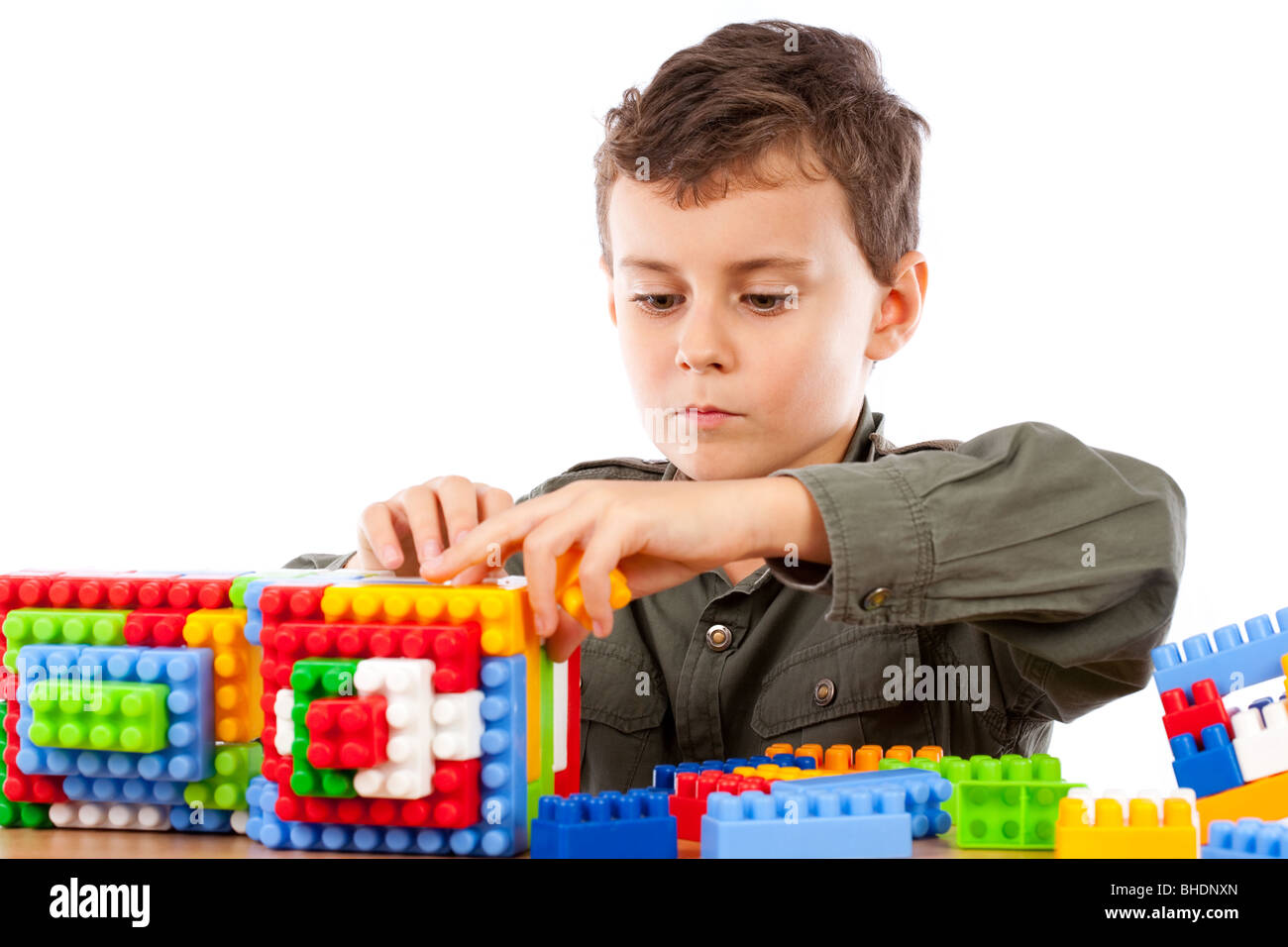 Cute kid playing with colorful plastic cubes, isolated on white ...