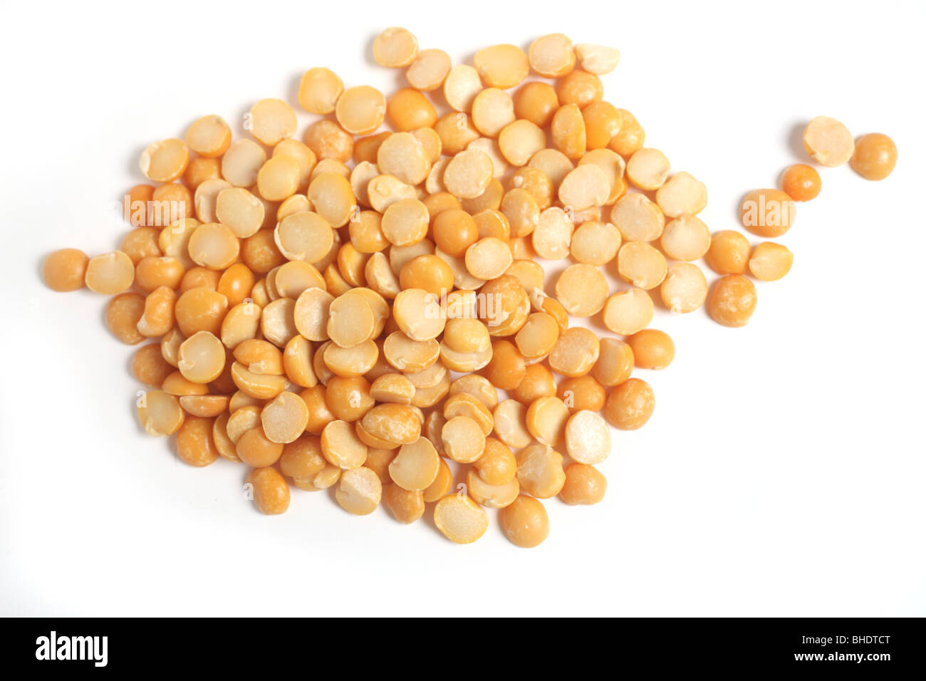 A view of split peas on a white background seen from above with a light ...