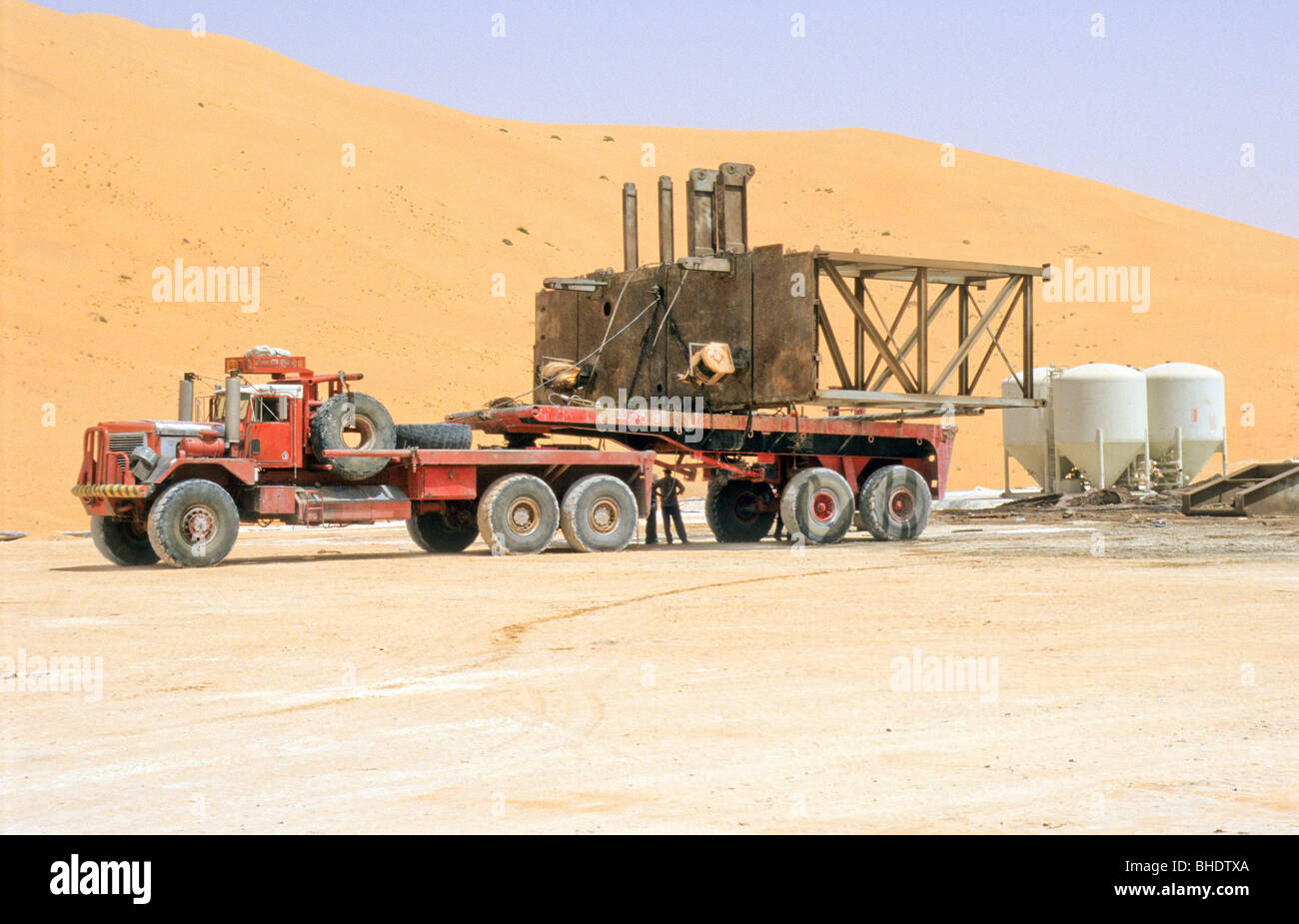 The platform of an oil drilling rig has been loaded onto the back of a ...