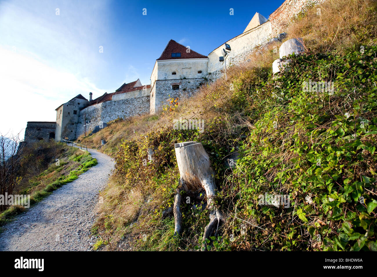 Landscape with medieval castle or fortress at sunset, under blue sky ...