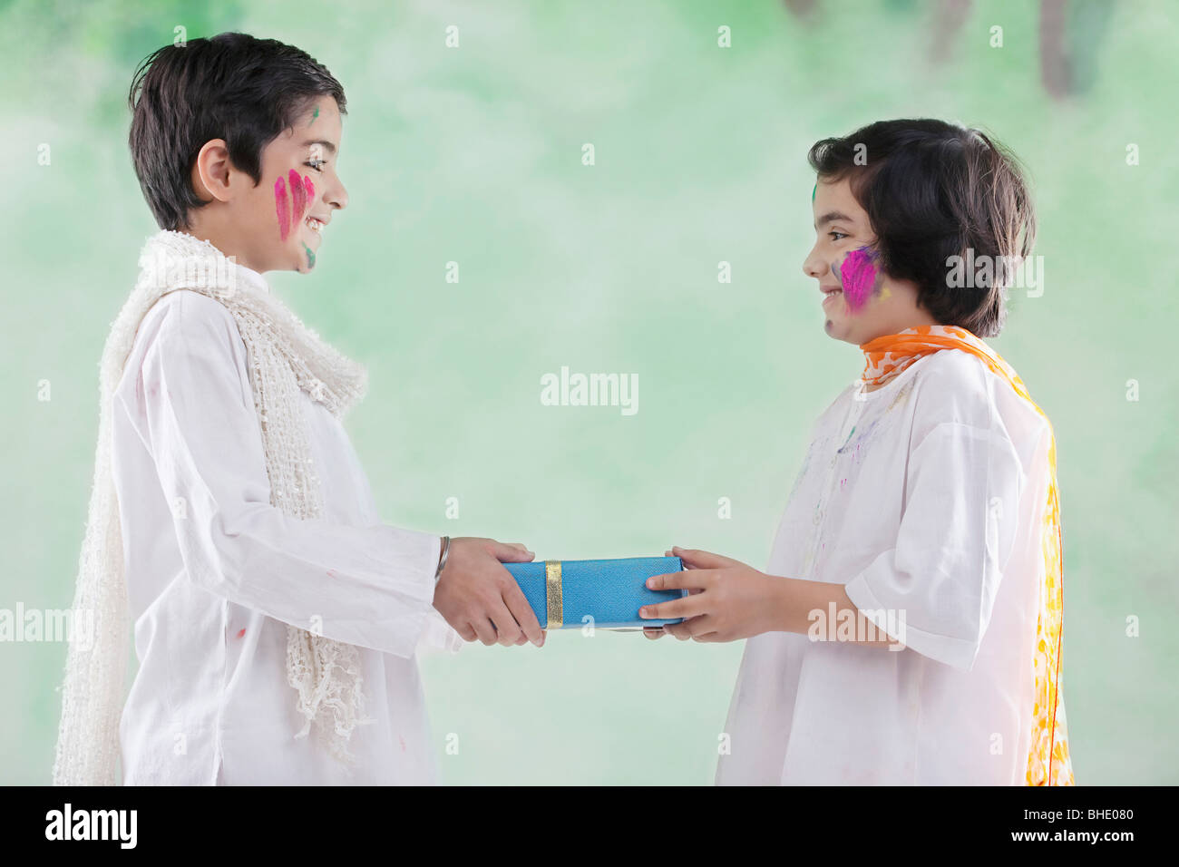 Boy and girl exchanging gifts Stock Photo - Alamy