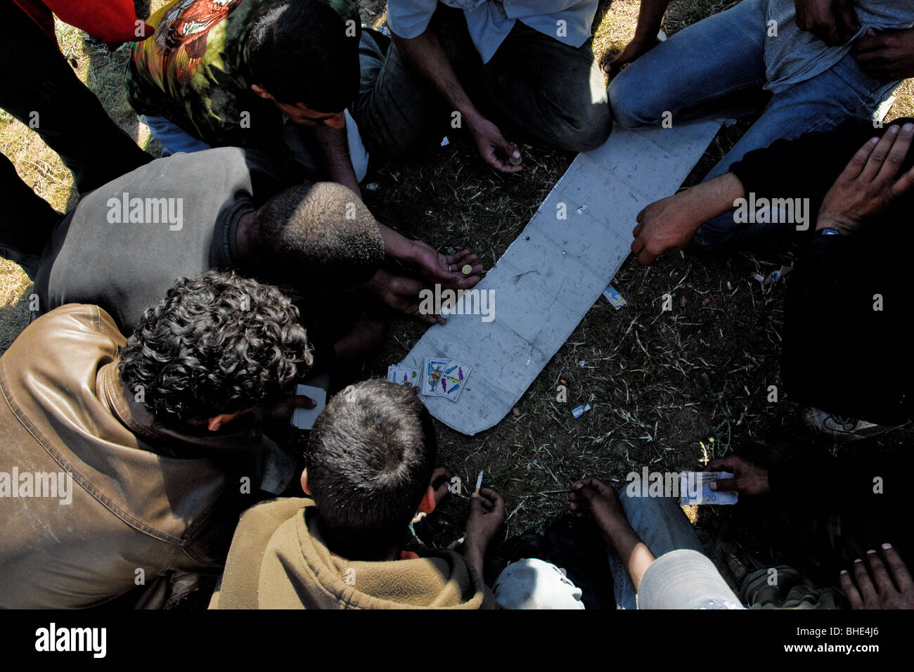 Haraga immigrants playing cards and waiting for the night to enter ...