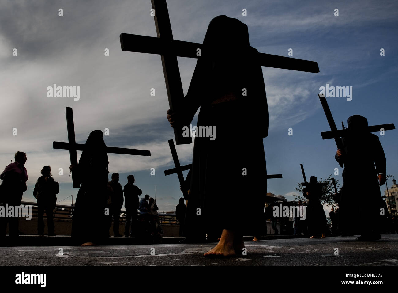 The Holy Week participants demonstrate their penance by carrying rough ...