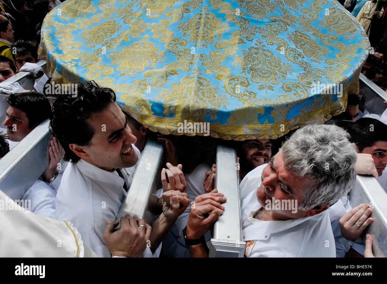 The brotherhood members carry the heavy throne and enter the narrow ...