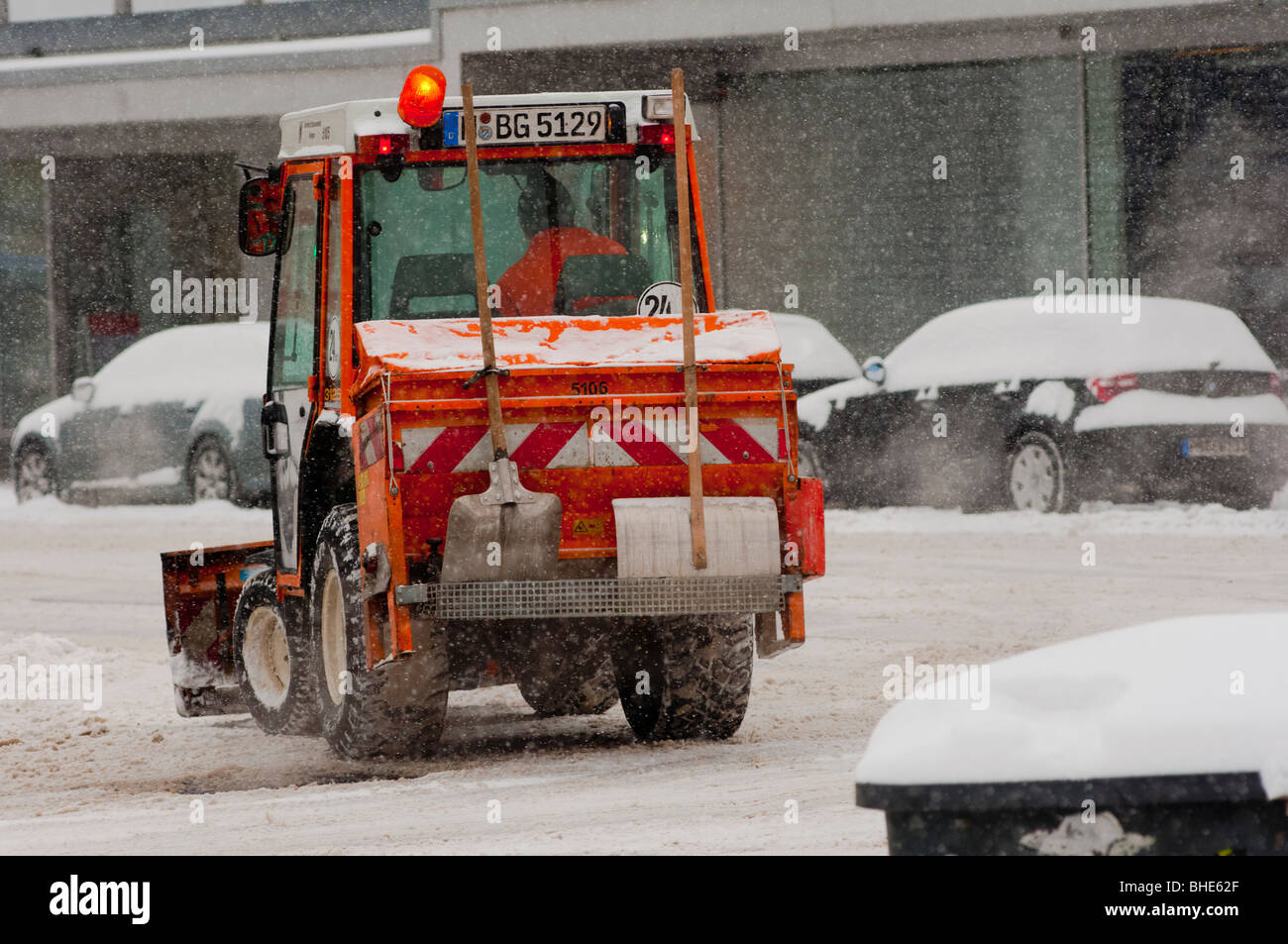Snow plough busy in a snow storm in Munich,Germany Stock Photo - Alamy