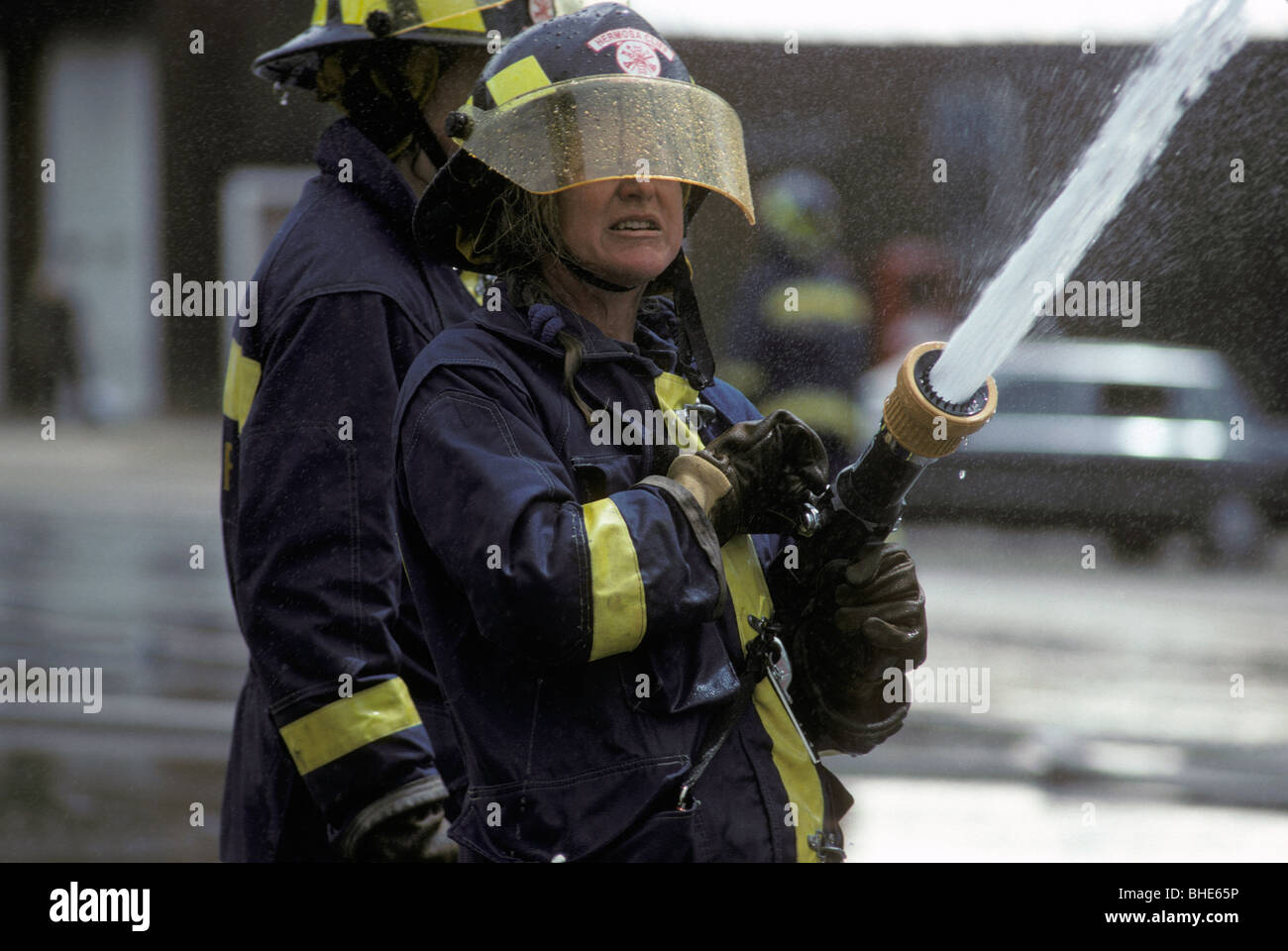 Firemen spray each other in a competition at the end of a Fourth of ...