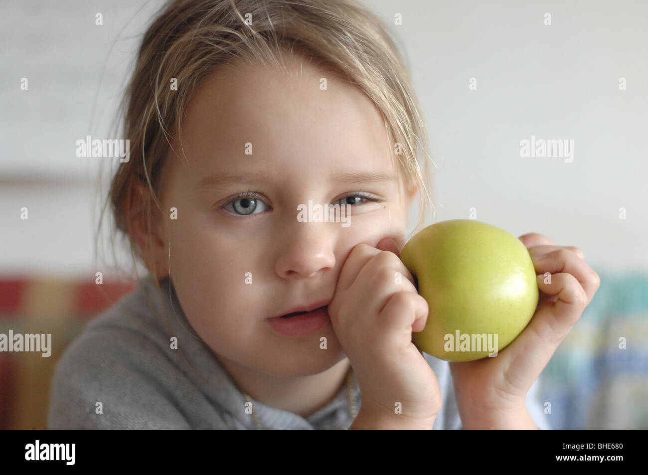 Ella enjoys an apple Stock Photo - Alamy