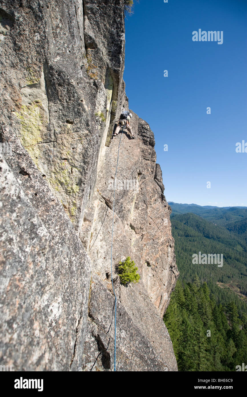 Rock climber climbing a steep face Stock Photo - Alamy