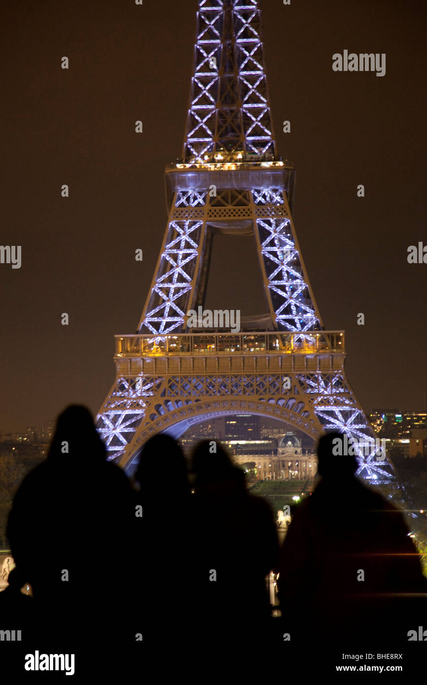 Family watching at the Eiffel tower during a lighting show Stock Photo ...