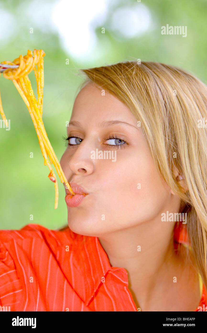 Young woman eating spaghetti on vacation Stock Photo - Alamy