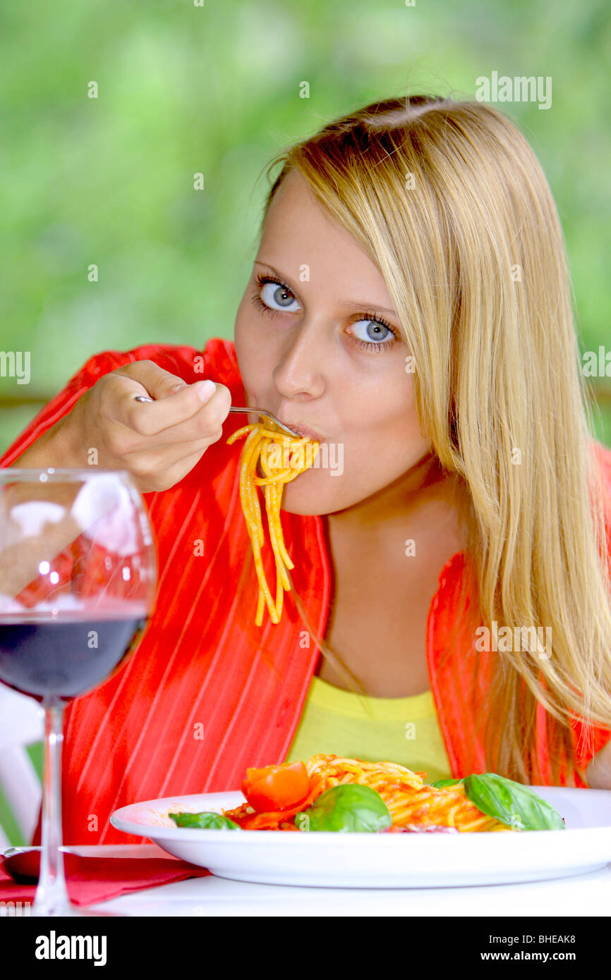 Young woman eating spaghetti on vacation Stock Photo - Alamy